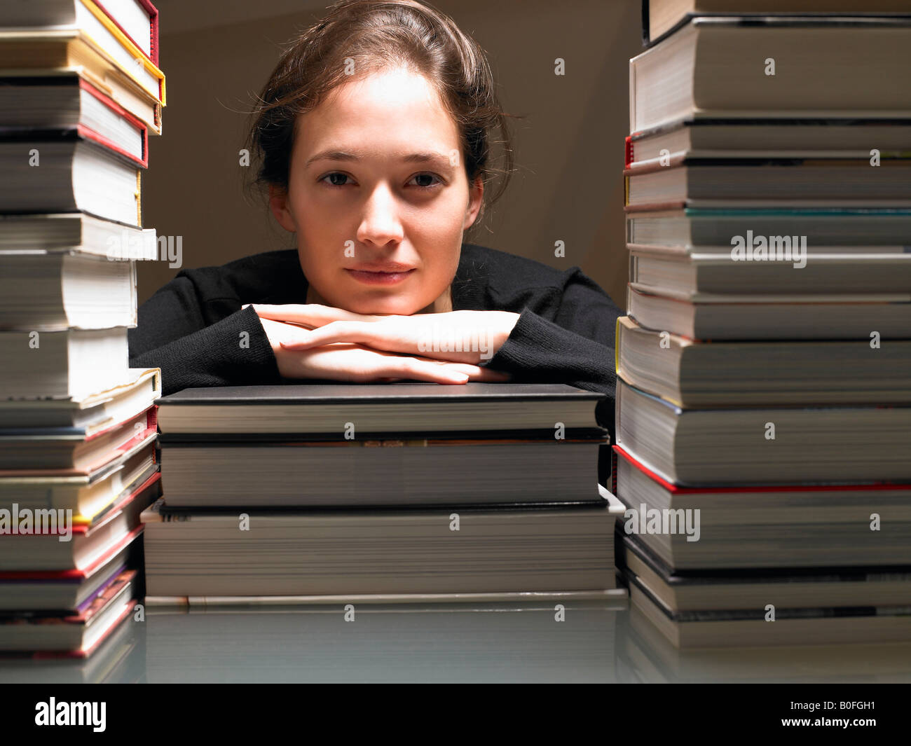 Woman sitting on stack books hi-res stock photography and images - Alamy