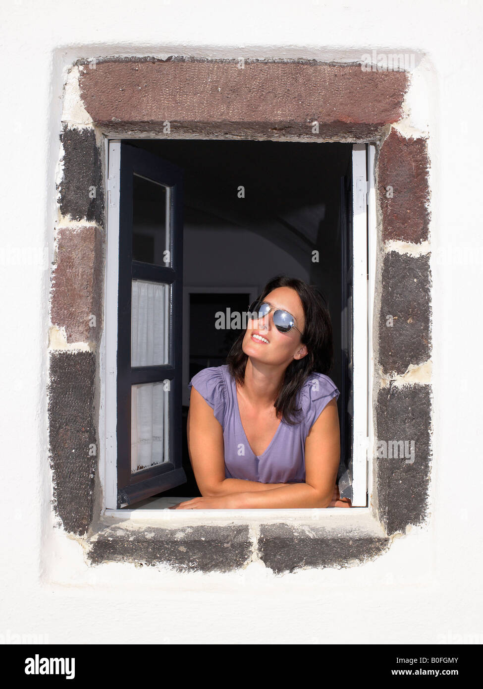 Woman looking through window, smiling Stock Photo - Alamy