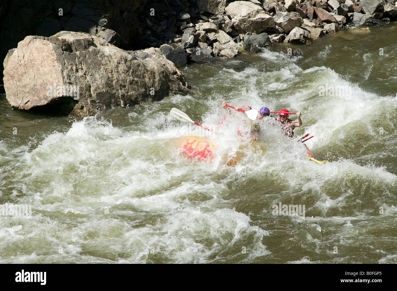 Nepalese river guide rowing a commercial raft through the Royal Gorge ...
