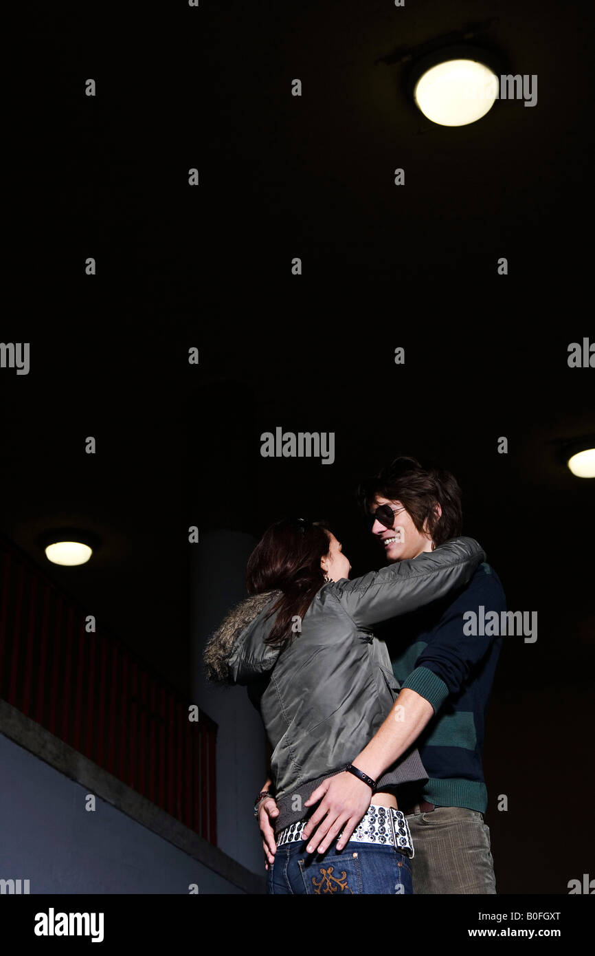 Young couple embracing low view Stock Photo - Alamy