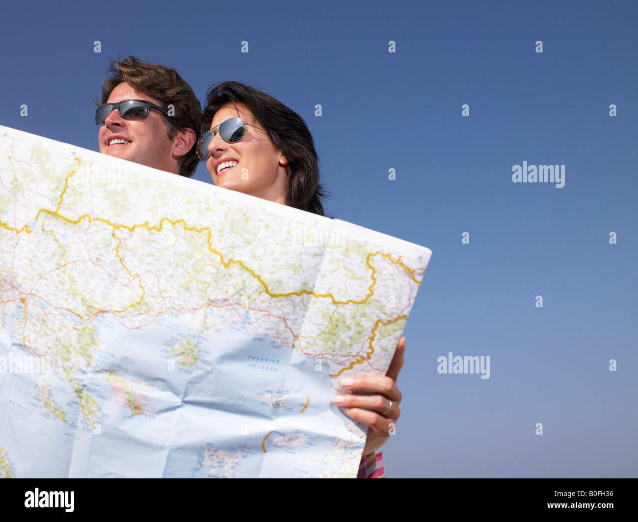 Couple looking at a map Stock Photo - Alamy