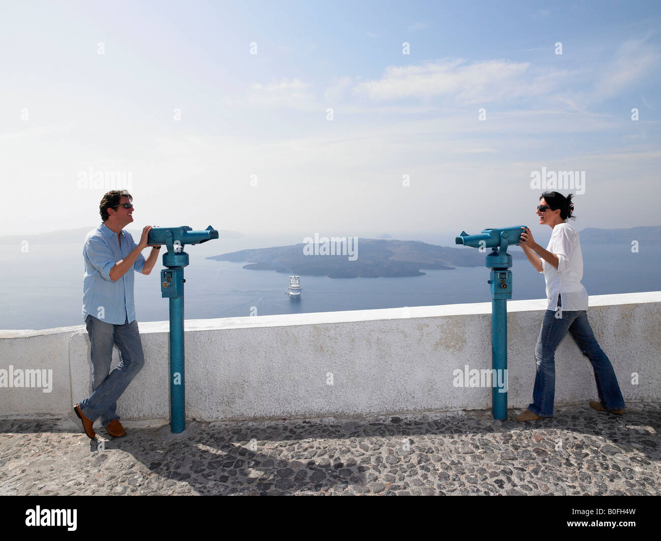Two people looking through telescope hi-res stock photography and ...