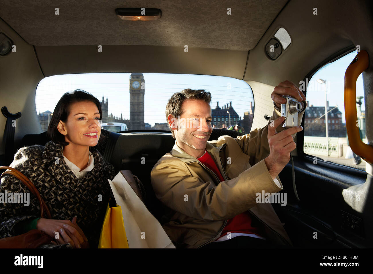 Couple in London taxi, Big Ben in view Stock Photo - Alamy