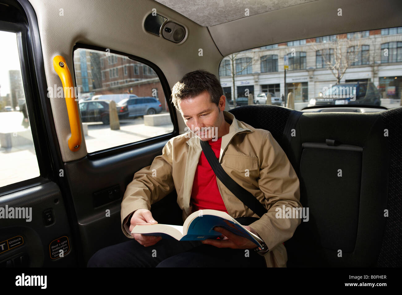 Man reading in London Taxi Stock Photo - Alamy