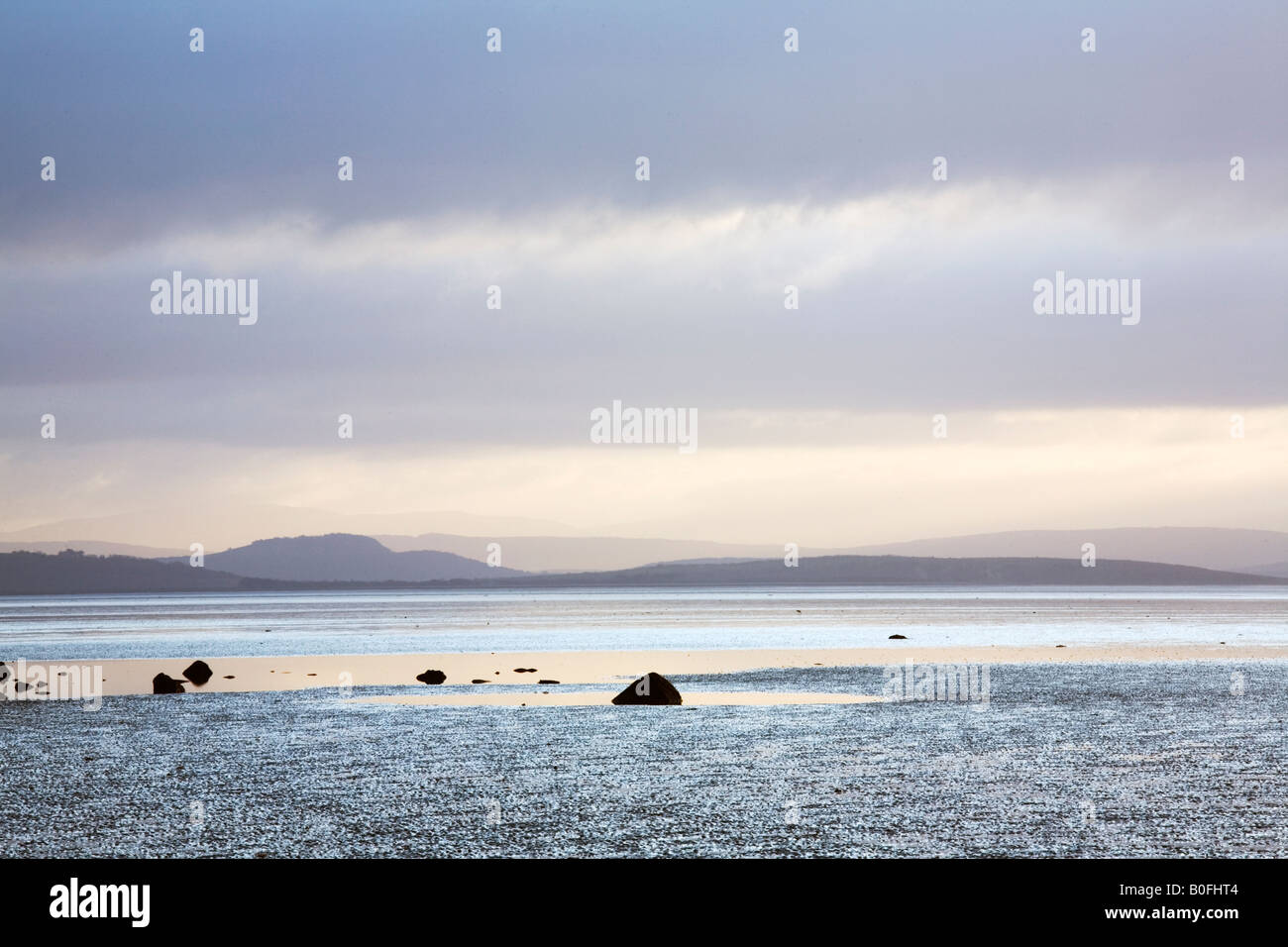 The muted colours of Morecambe Bay soon after a cloudy dawn from the ...