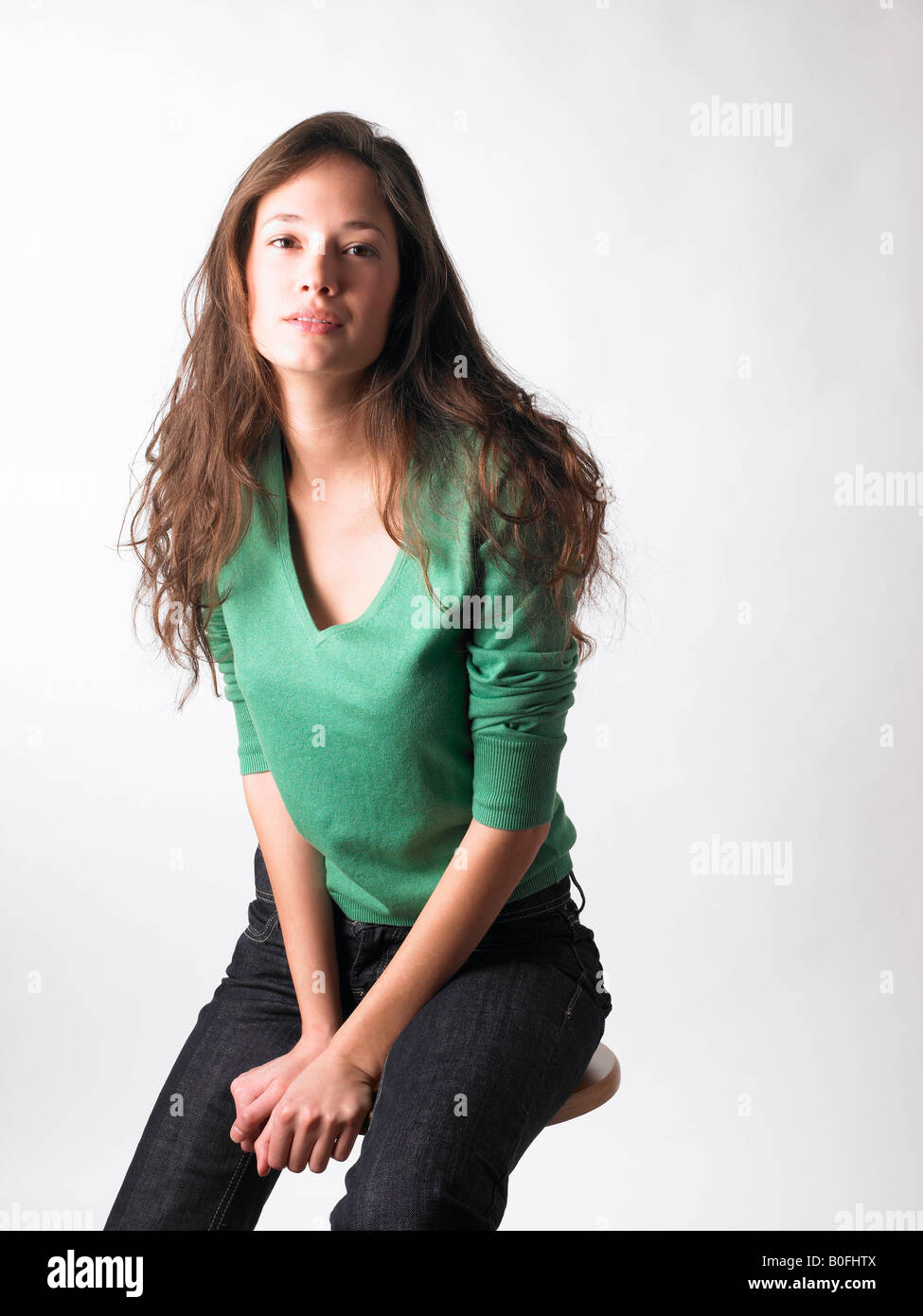 Woman sitting on a stool Stock Photo - Alamy