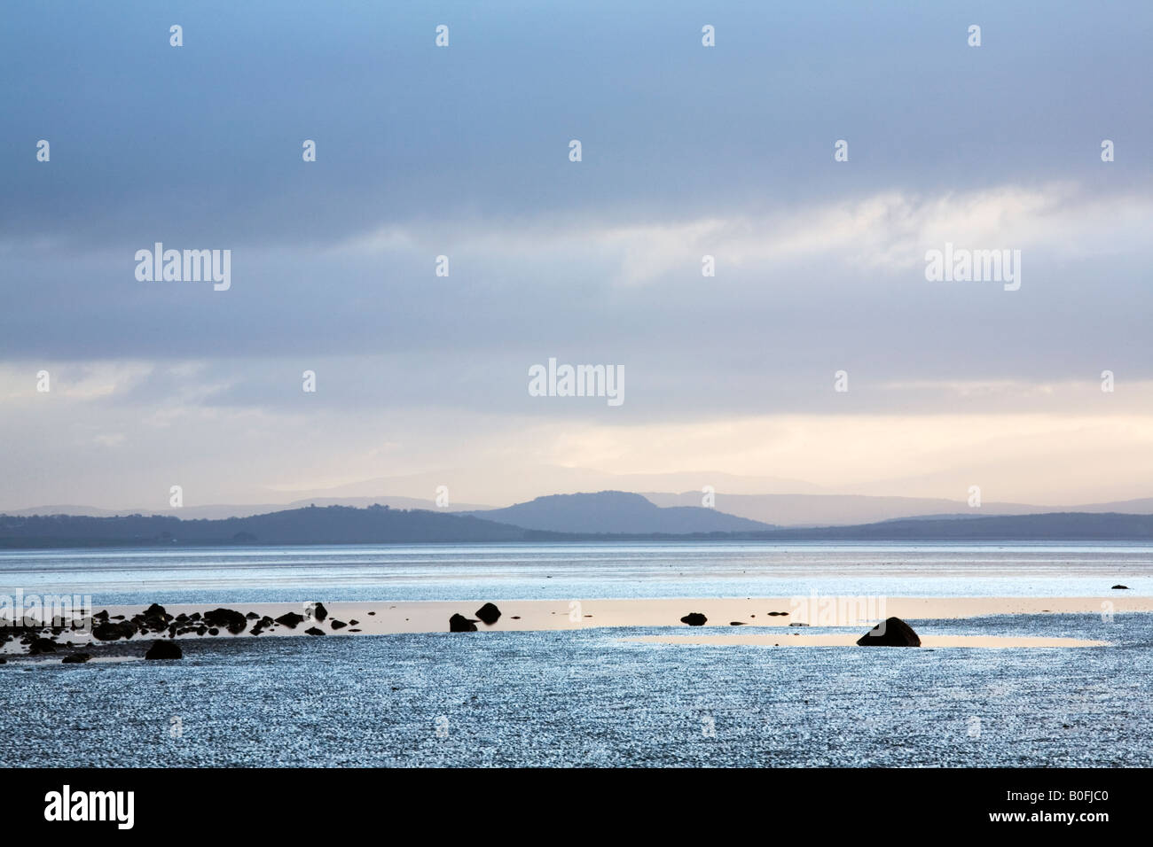 The muted colours of Morecambe Bay soon after a cloudy dawn from the ...