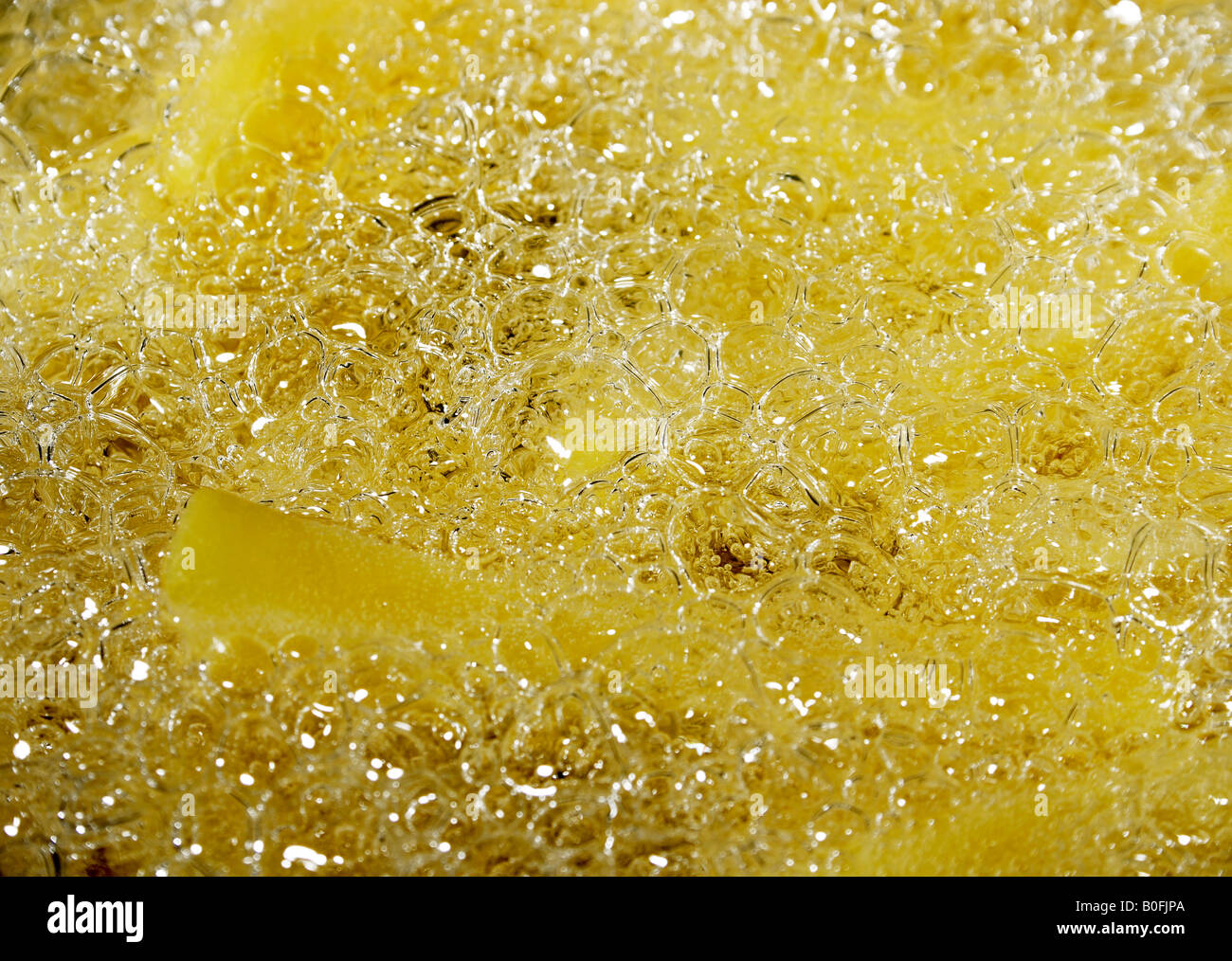 baking french fries chips in oil close up photo Stock Photo - Alamy