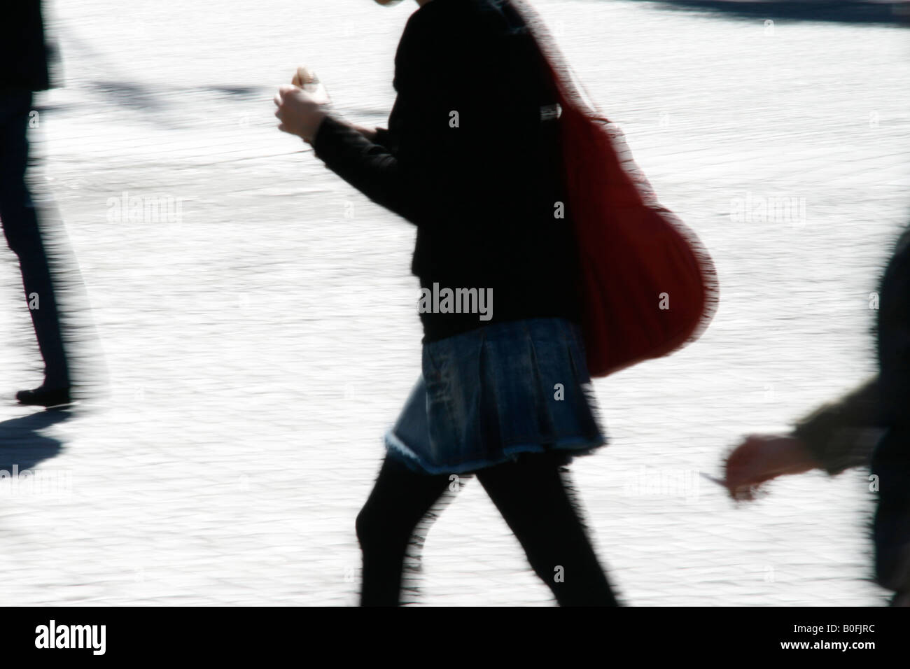 one person walking in street in city town Stock Photo - Alamy