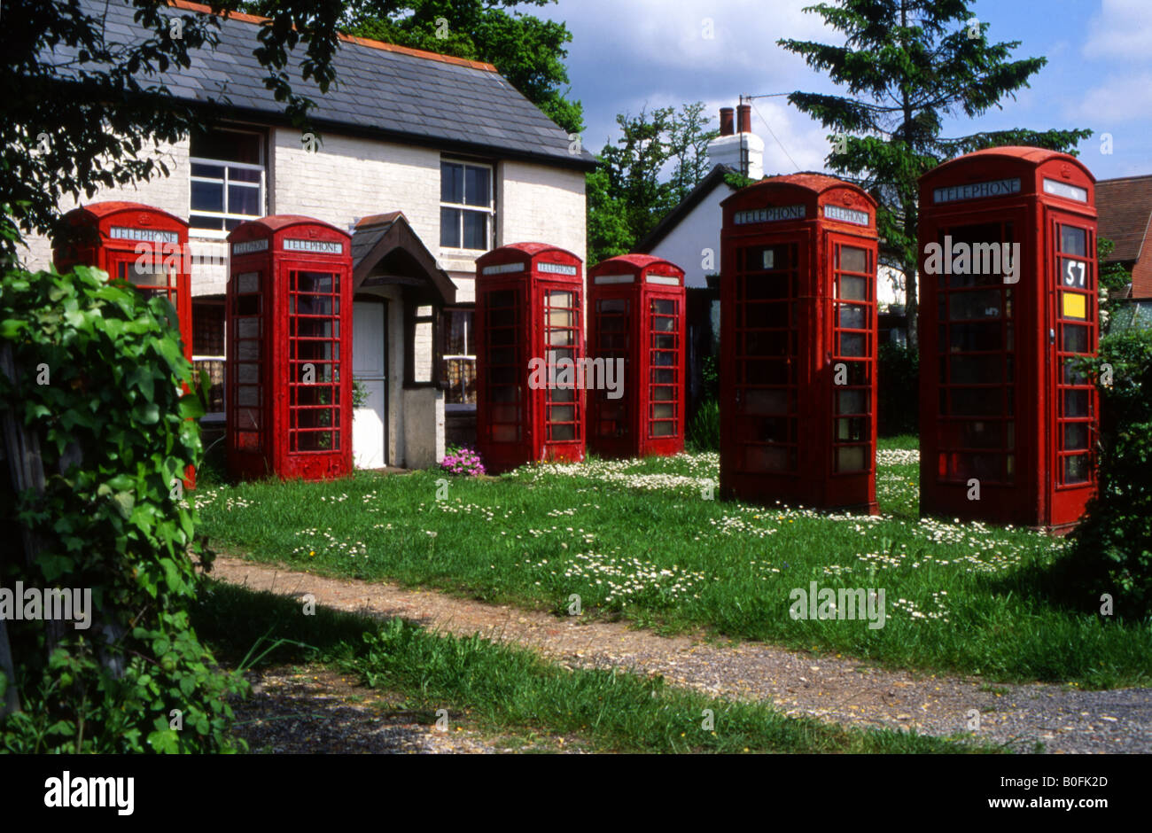 collection of traditional british red telephone boxes standing in a ...