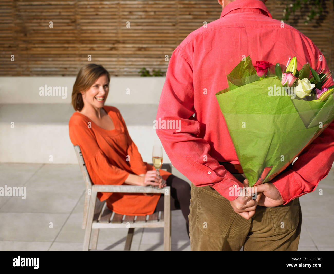Husband hiding flower behind back hi-res stock photography and images ...
