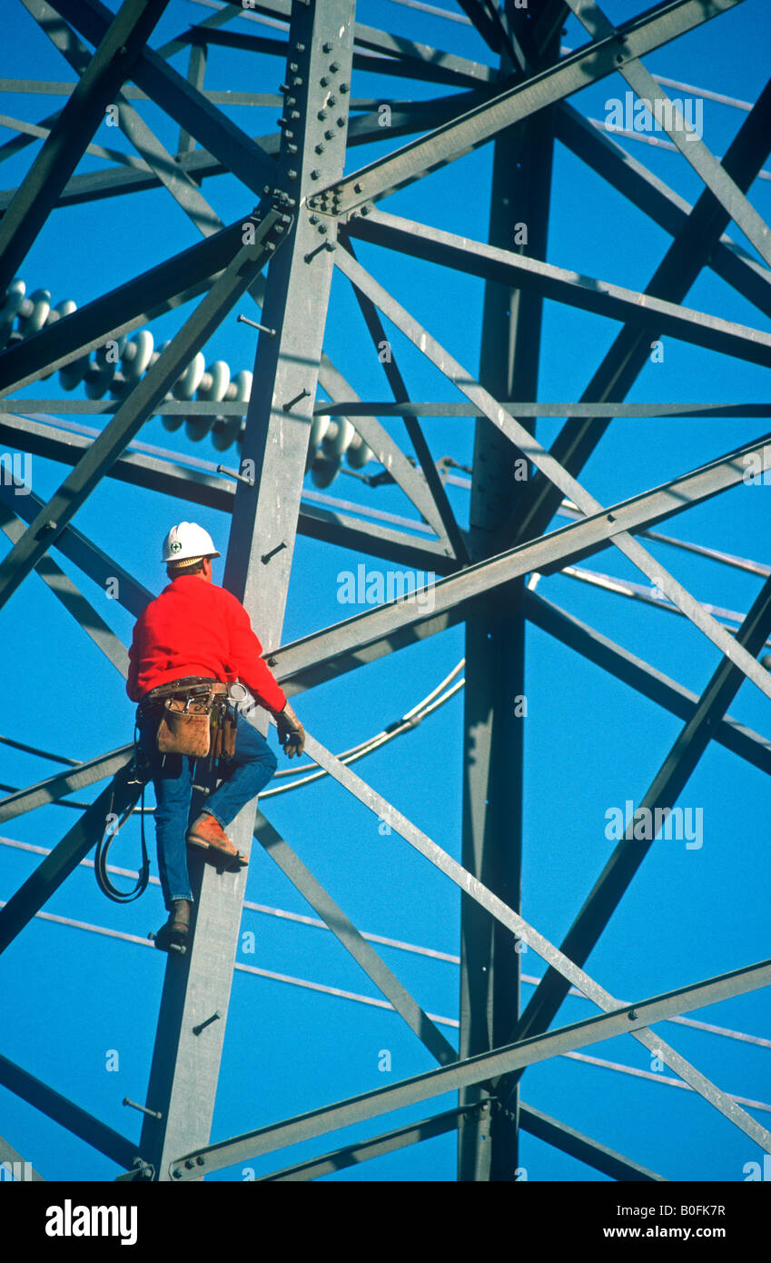 Electrical worker climbs a steel electrical tower Stock Photo - Alamy