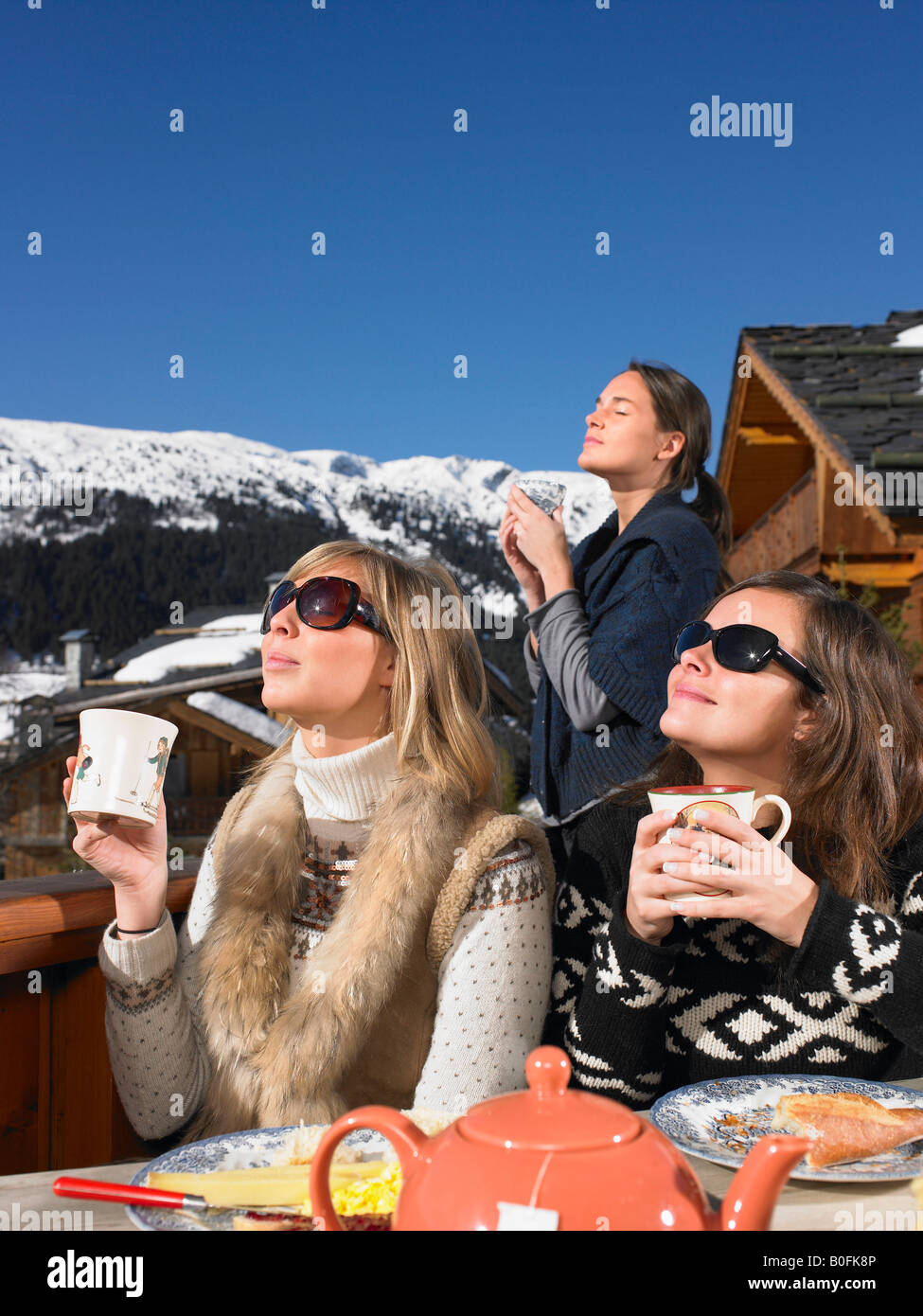 Young women having breakfast on terrace Stock Photo - Alamy