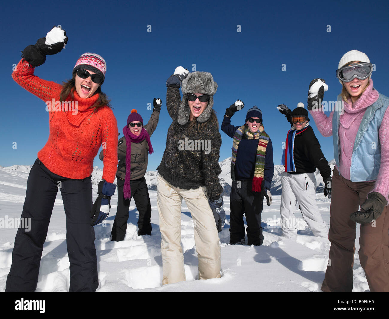 Group throwing snowballs Stock Photo - Alamy