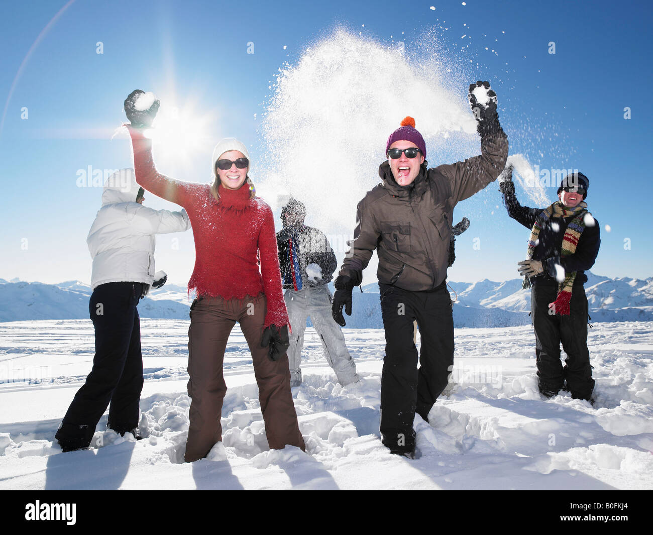Group throwing snowballs Stock Photo - Alamy