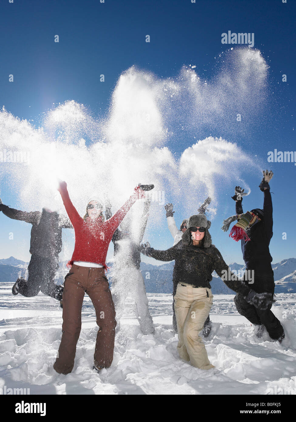 Group throwing snowballs in air Stock Photo - Alamy