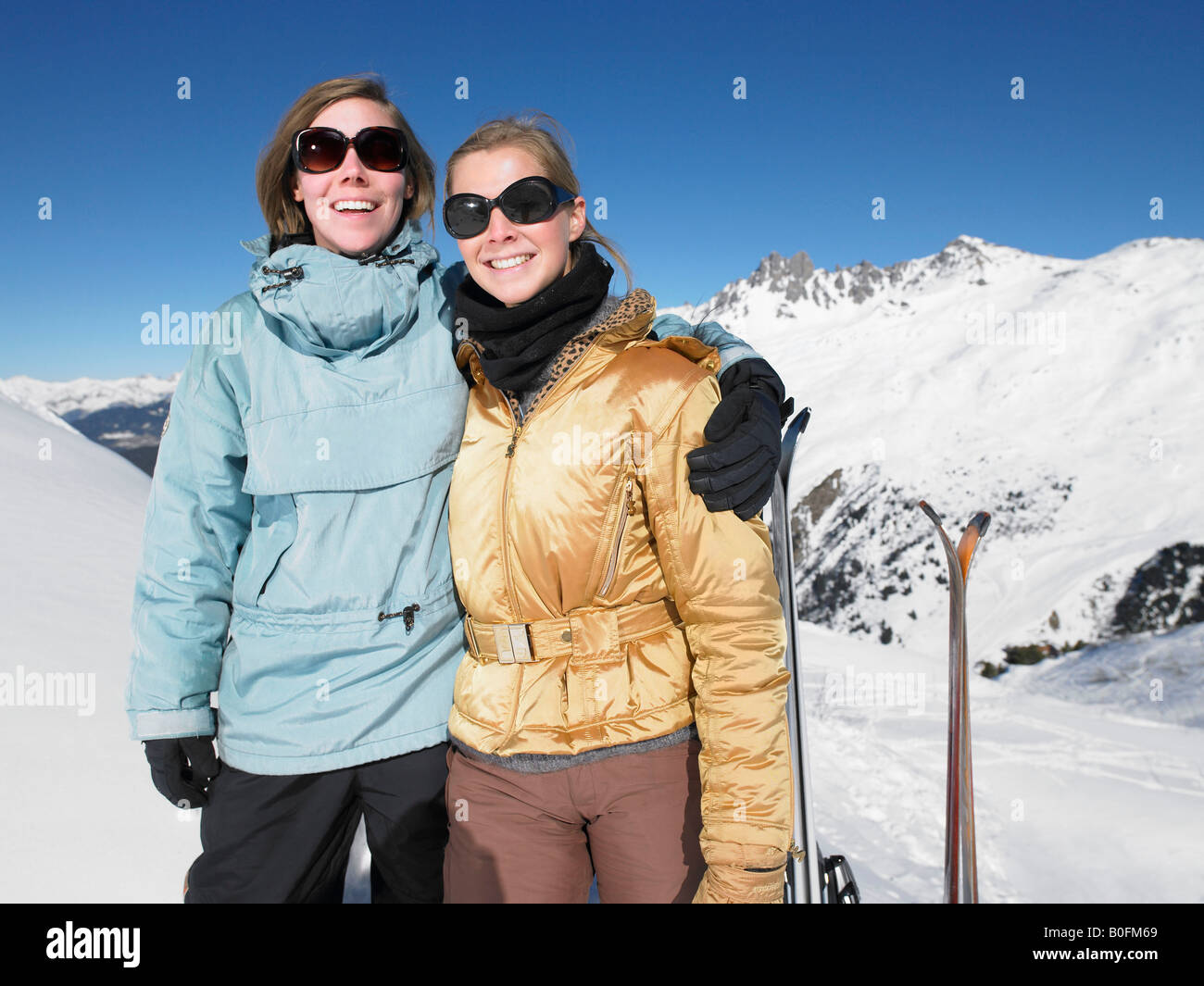 Smiling young women on mountain top Stock Photo - Alamy