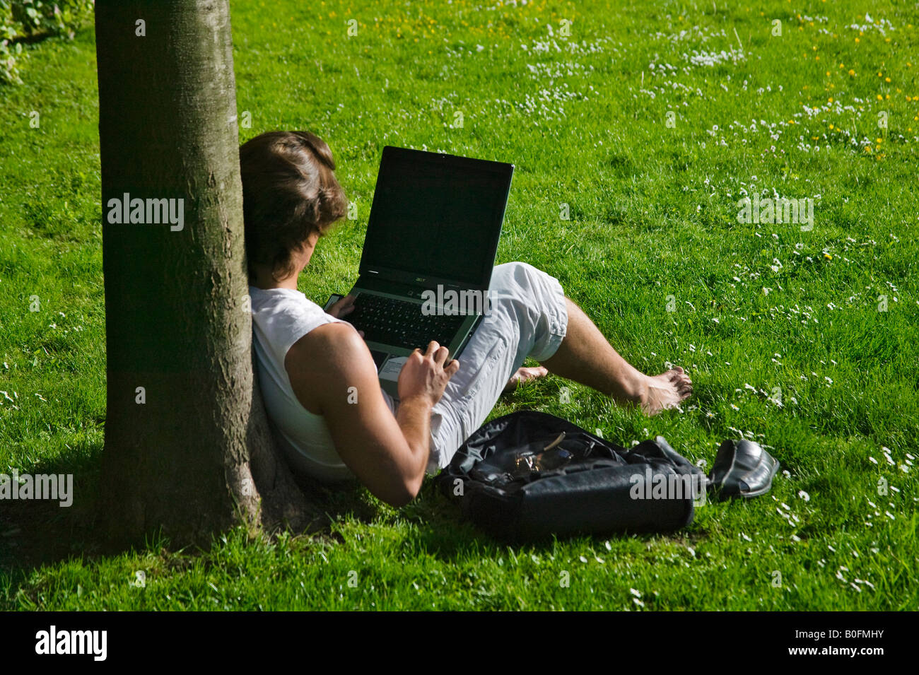 Girl with laptop on grass hi-res stock photography and images - Alamy