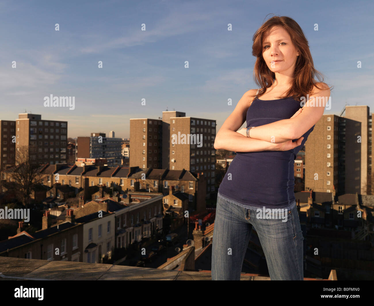 Woman standing on roof terrace Stock Photo - Alamy