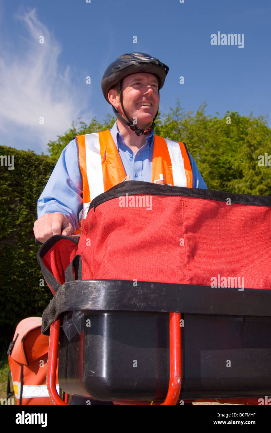 A Postman On His Round in the Uk in Spring Stock Photo - Alamy