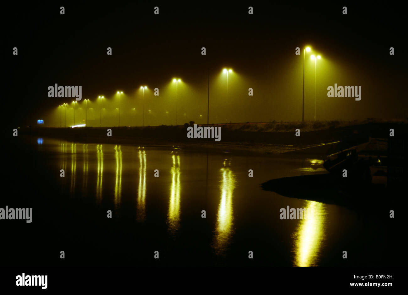 motorway street lights glow eerily through the fog portsmouth uk Stock ...