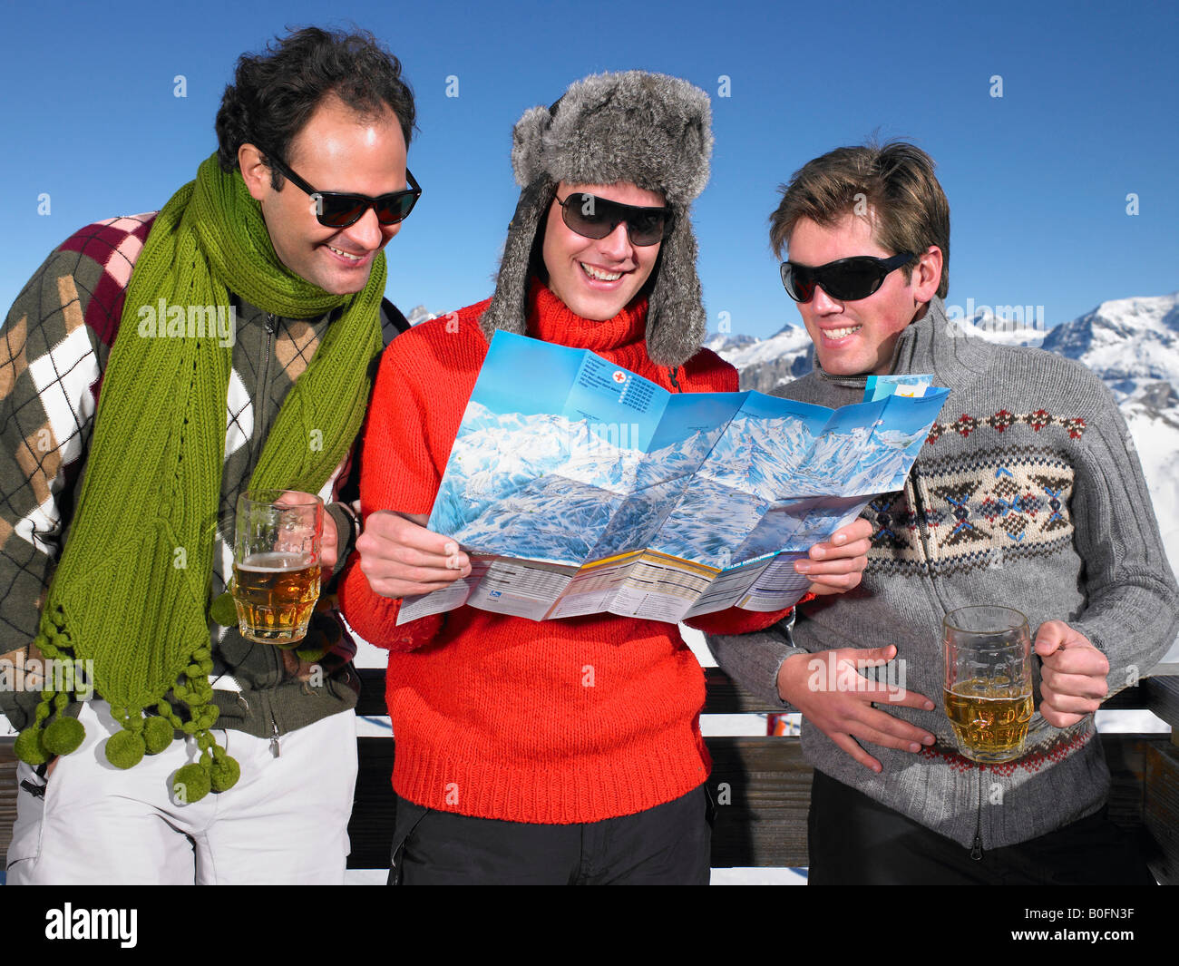 Young men looking at map Stock Photo - Alamy
