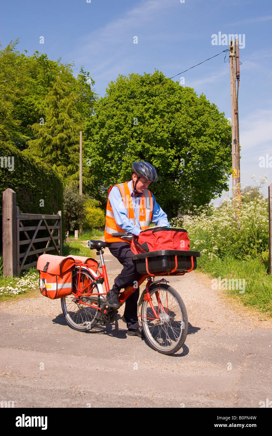 A Postman On His Round in the Uk in Spring Stock Photo - Alamy