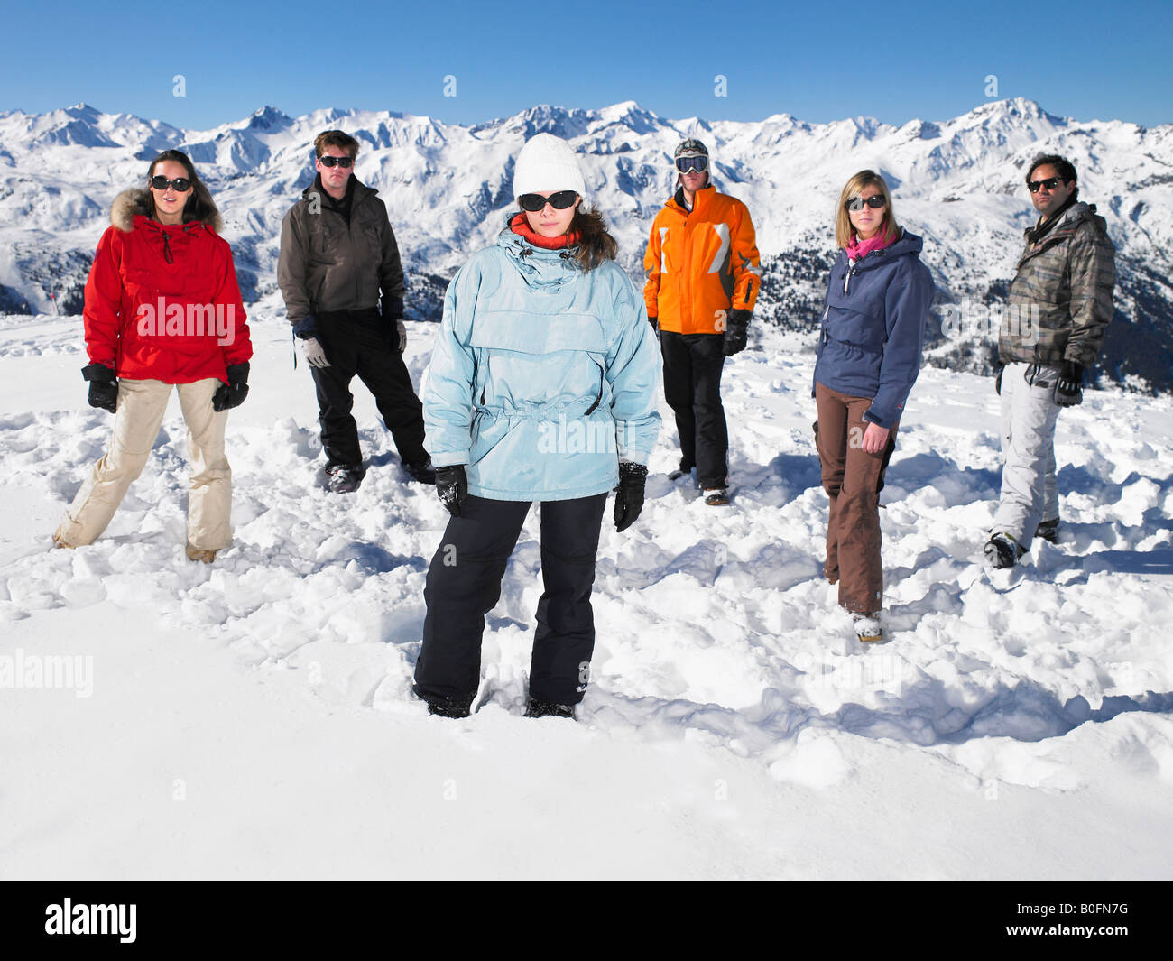 Group standing in snow Stock Photo - Alamy