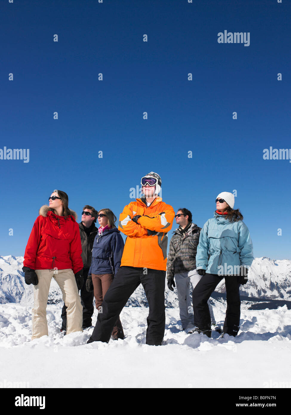 Group standing in snow Stock Photo - Alamy