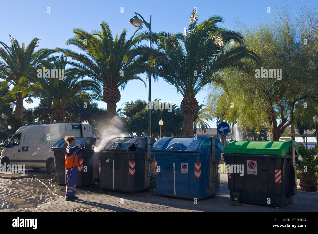 Pressure cleaning garbage bins along in the City of Almeria, Costa de ...
