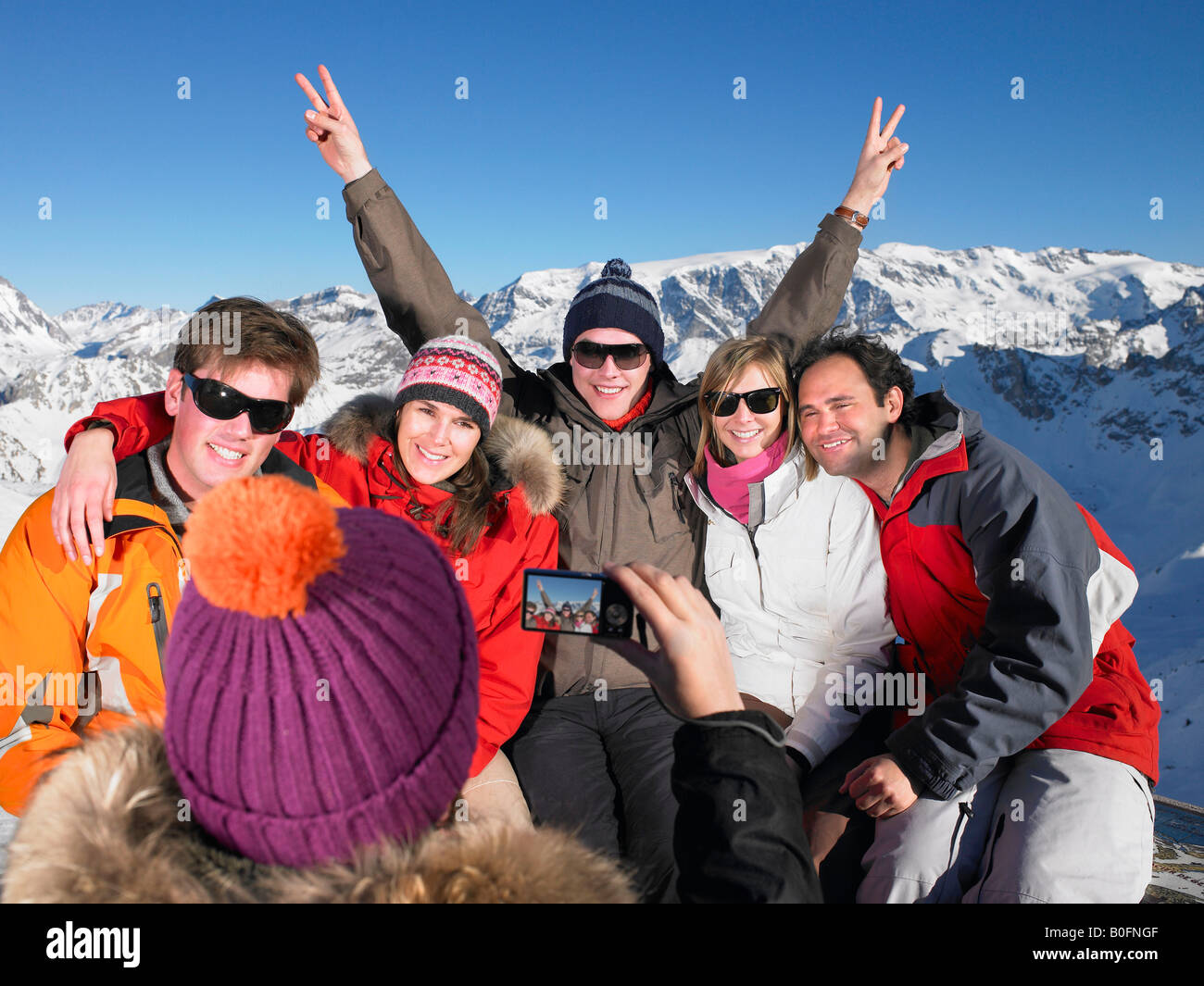 Young woman taking picture of group Stock Photo - Alamy