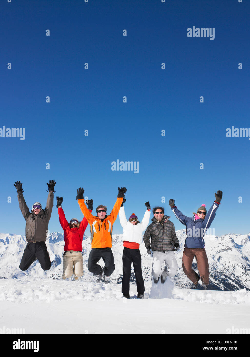 Group jumping in snow Stock Photo - Alamy