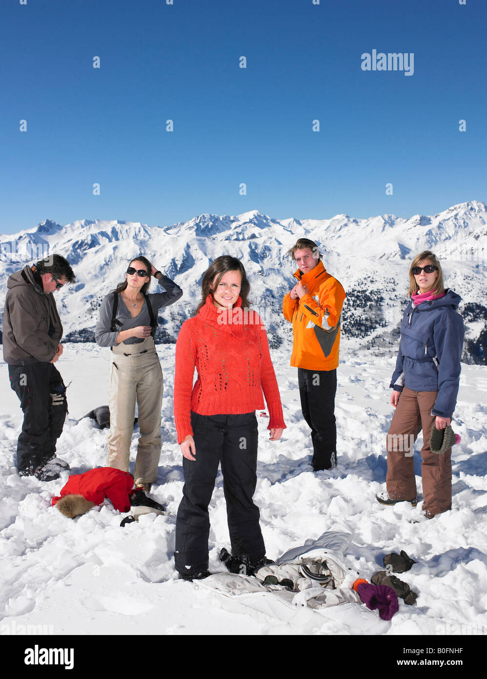 Group changing in snow Stock Photo - Alamy
