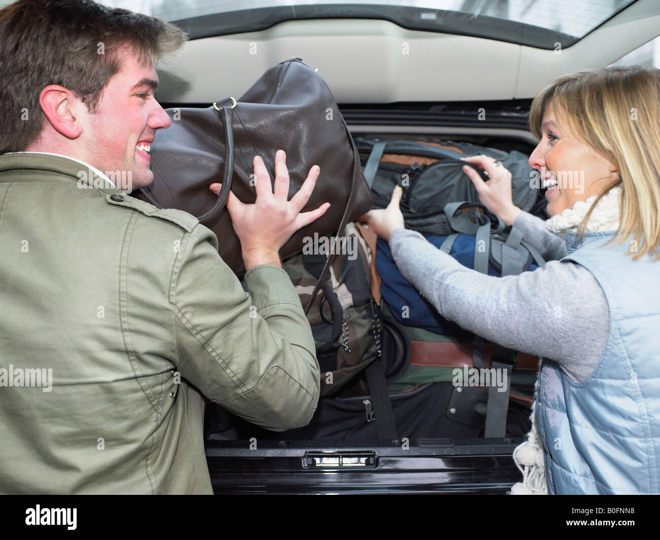 Couple packing car Stock Photo - Alamy