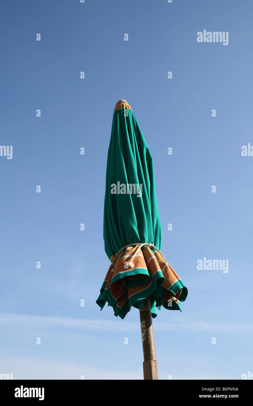 closed beach umbrella on seaside resort with blue sky and sun Stock ...