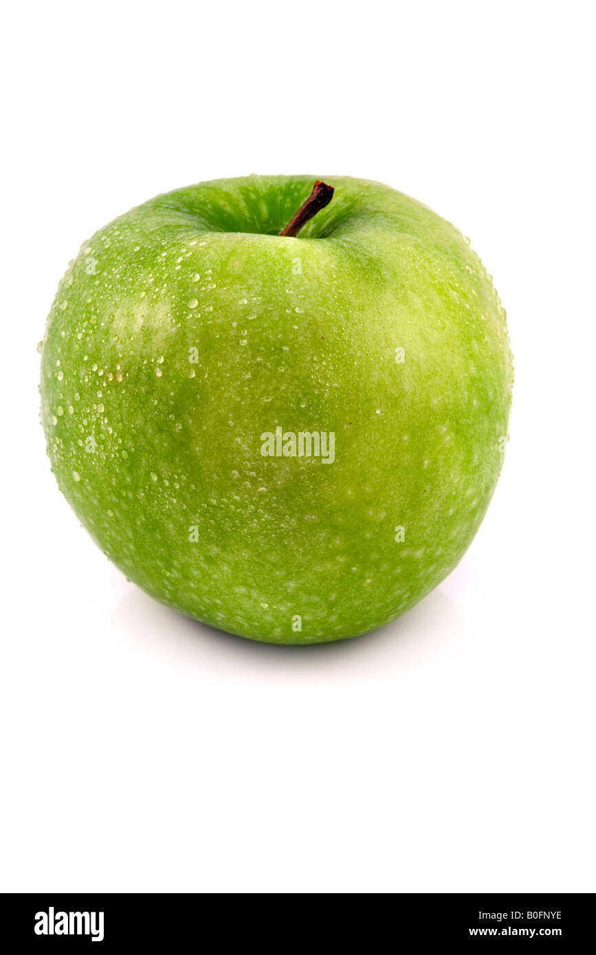 A single green apple, glistening with moisture, isolated on a white ...