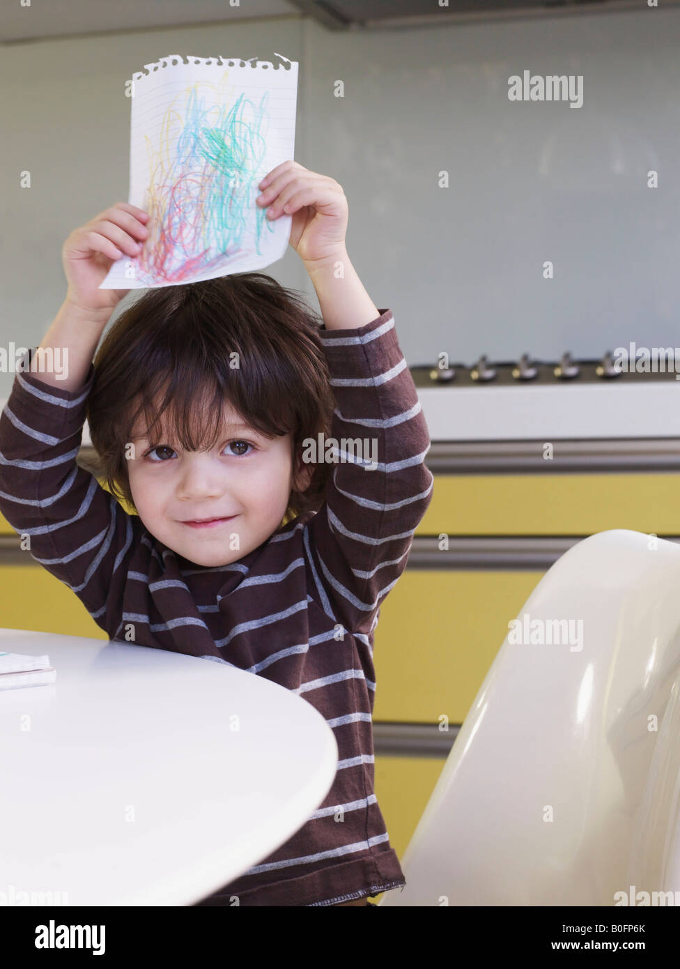 Boy holding up drawing Stock Photo - Alamy