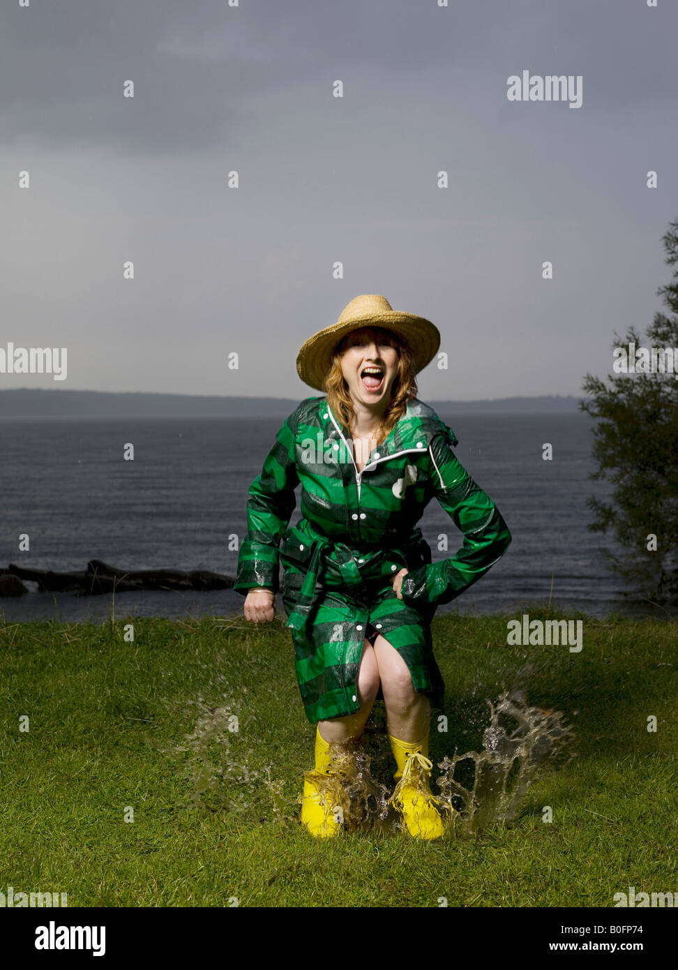 Woman jumping in water puddle Stock Photo - Alamy