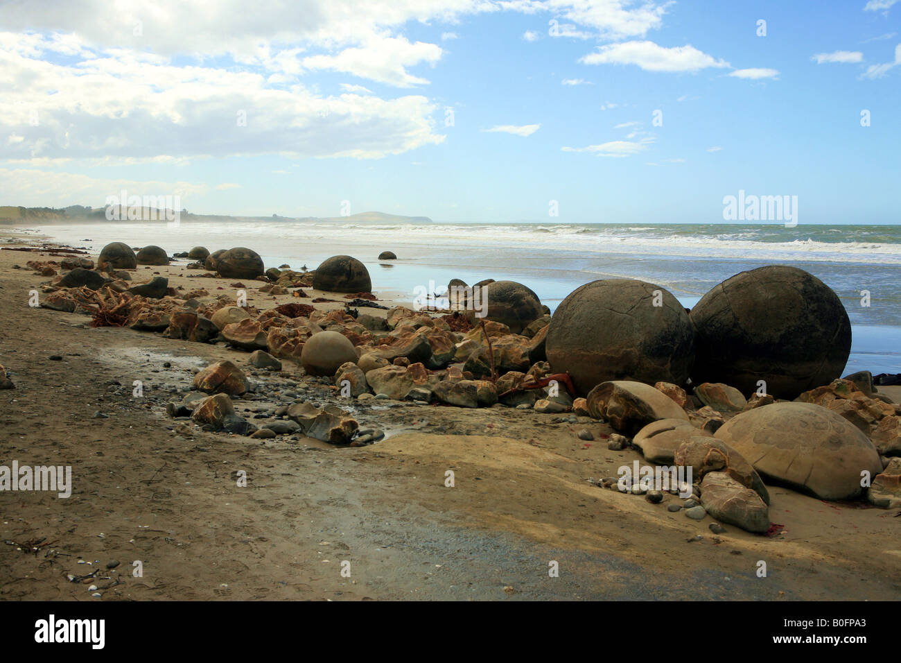 60 million year old Giant ball shaped boulders on the beach at Moeraki ...