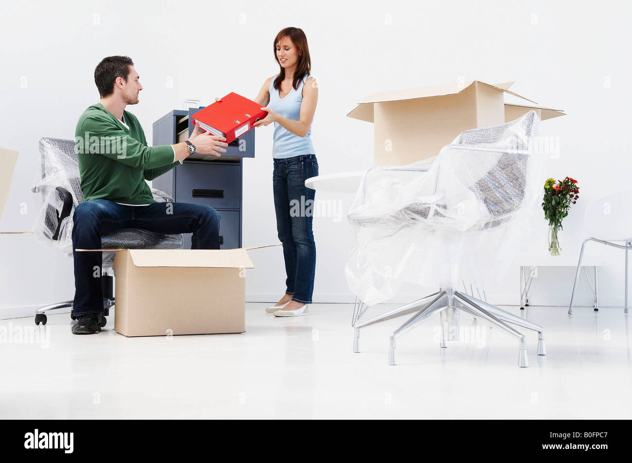 People setting up new office Stock Photo - Alamy