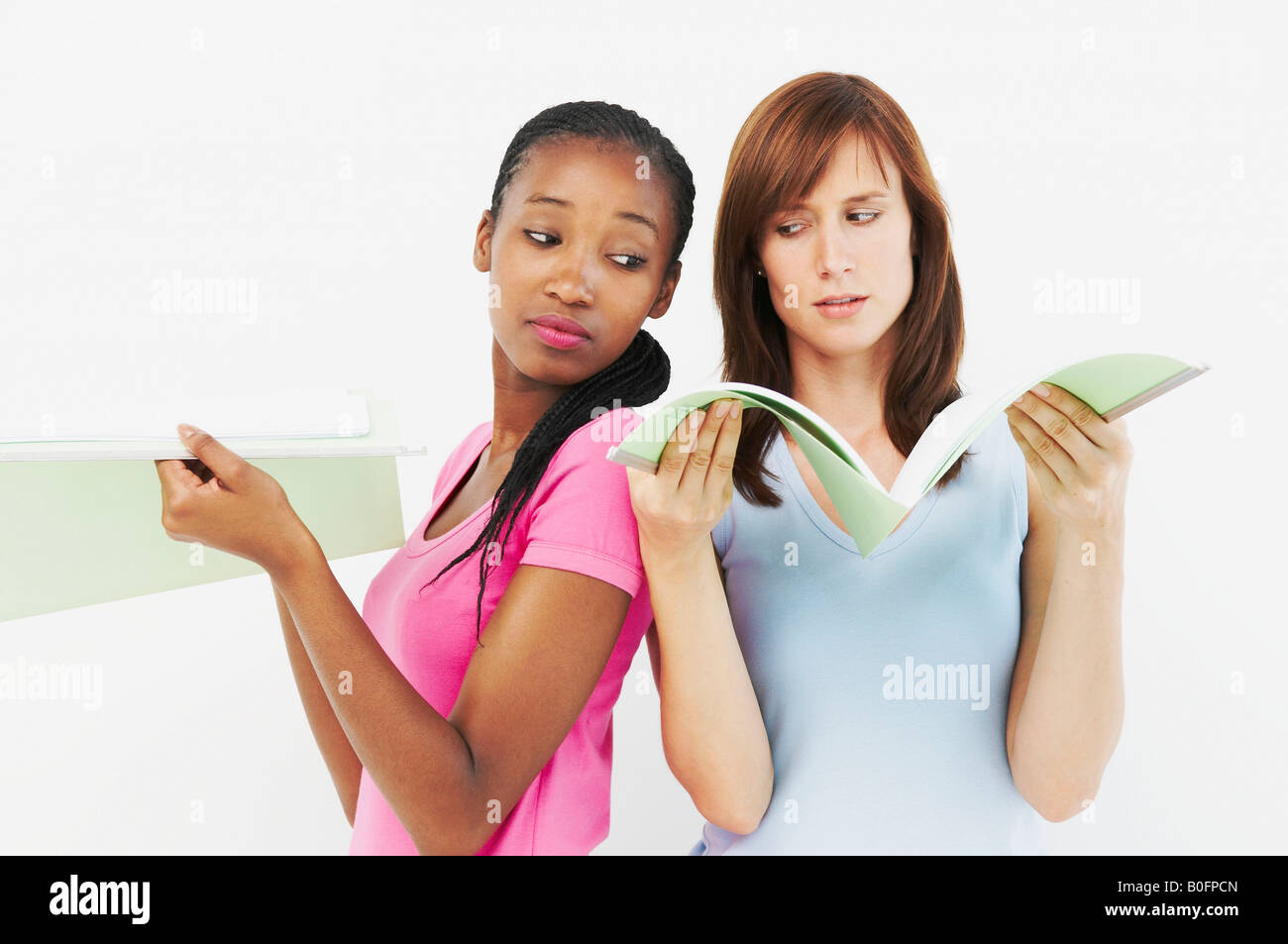 Two women looking at files Stock Photo - Alamy