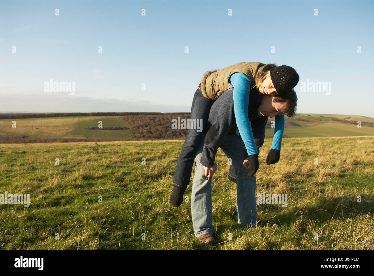 Woman Standing On Mans Back