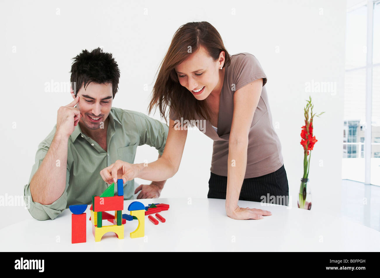 Man and woman happily build model house Stock Photo - Alamy