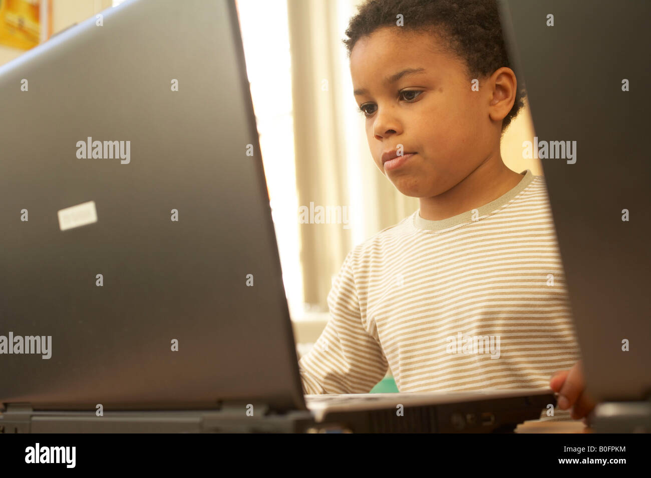 Boy on computer Stock Photo - Alamy