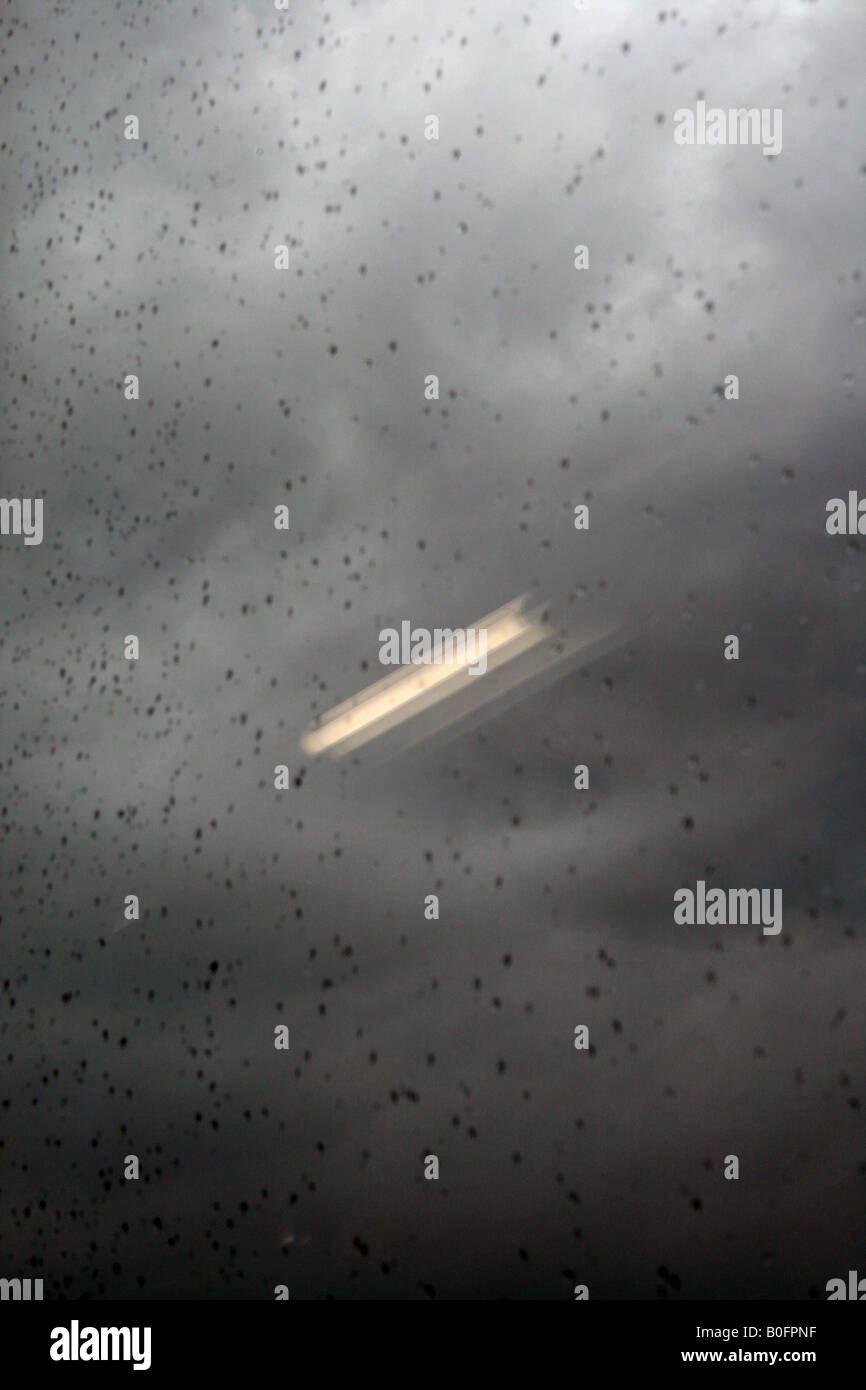 light bulb reflection on window with rain drops Stock Photo - Alamy