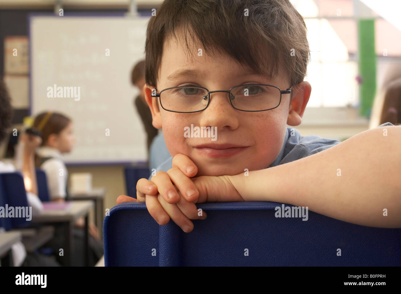 Boy looking at camera, in classroom Stock Photo - Alamy