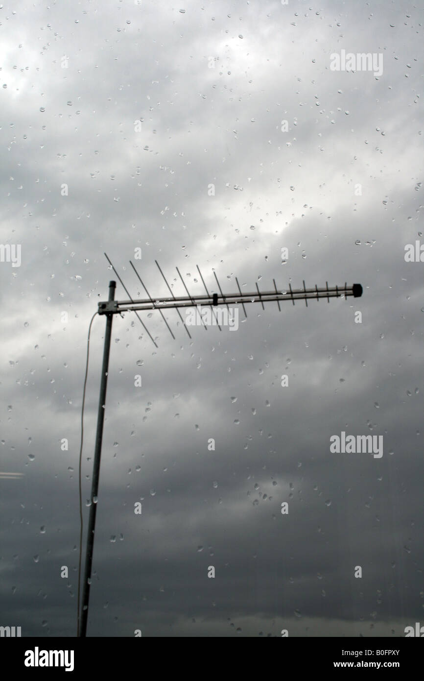 tv aerial reflection on window with rain drops Stock Photo - Alamy