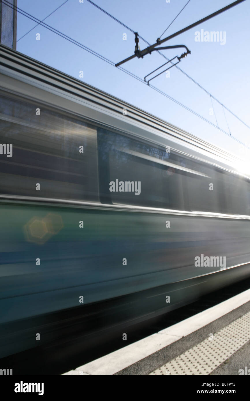high speed train passing platform in station Stock Photo - Alamy