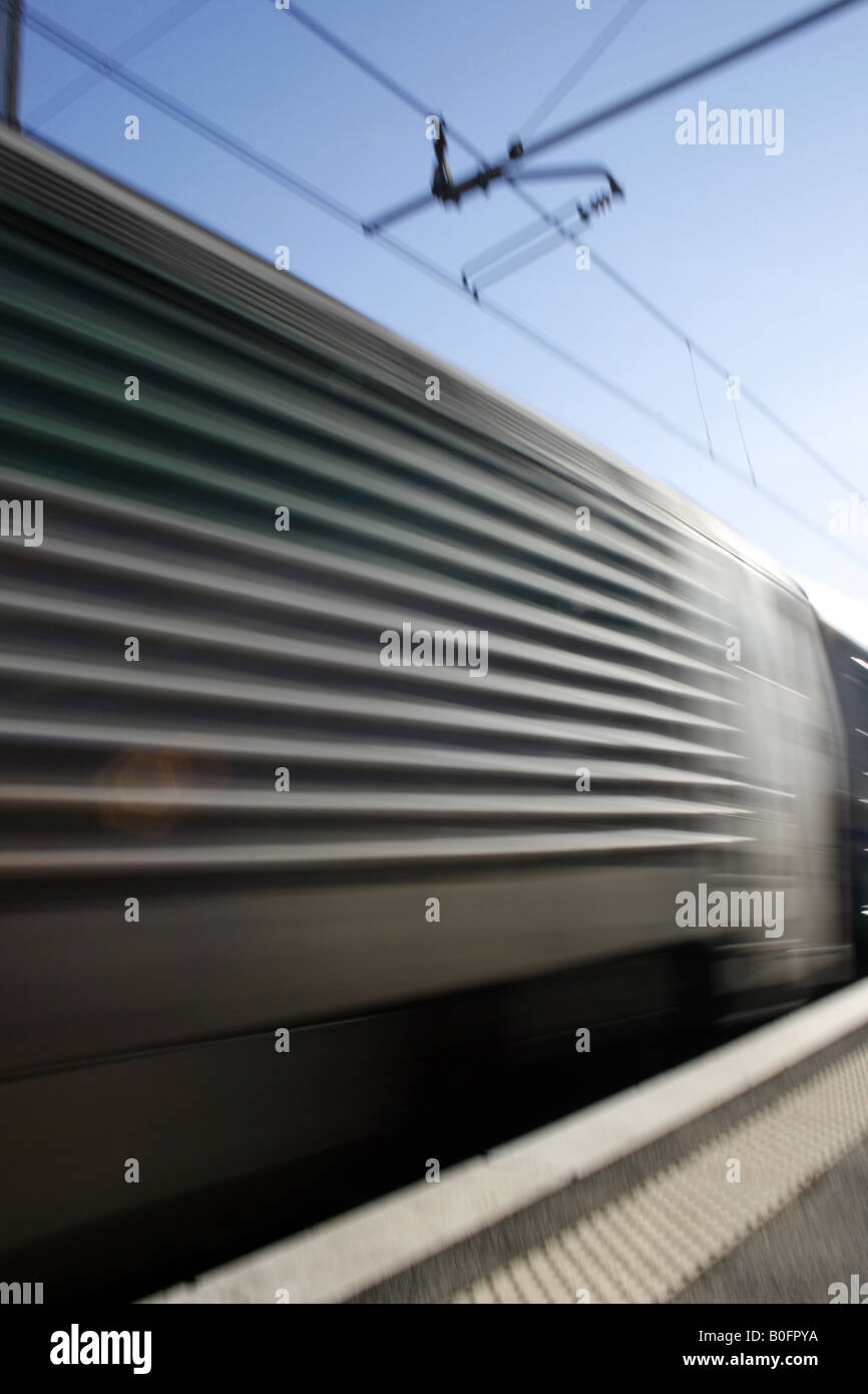 high speed train passing platform in station Stock Photo - Alamy