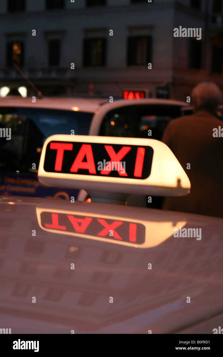 taxi sign in street at night Stock Photo - Alamy